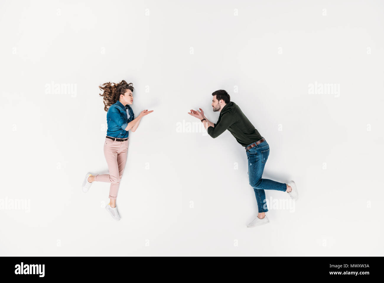 top view of woman throwing blown kiss to boyfriend isolated on white ...