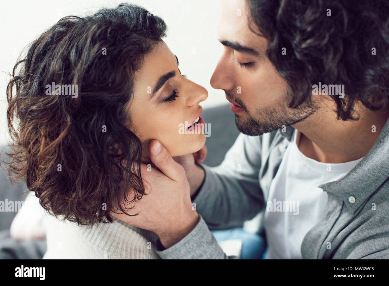 affectionate couple going to kiss at home Stock Photo - Alamy