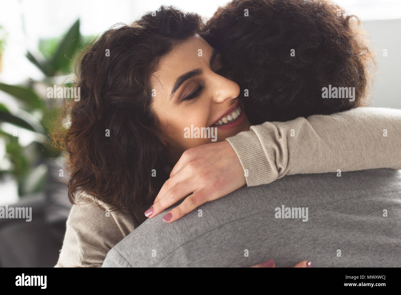 happy young couple cuddling at home Stock Photo - Alamy