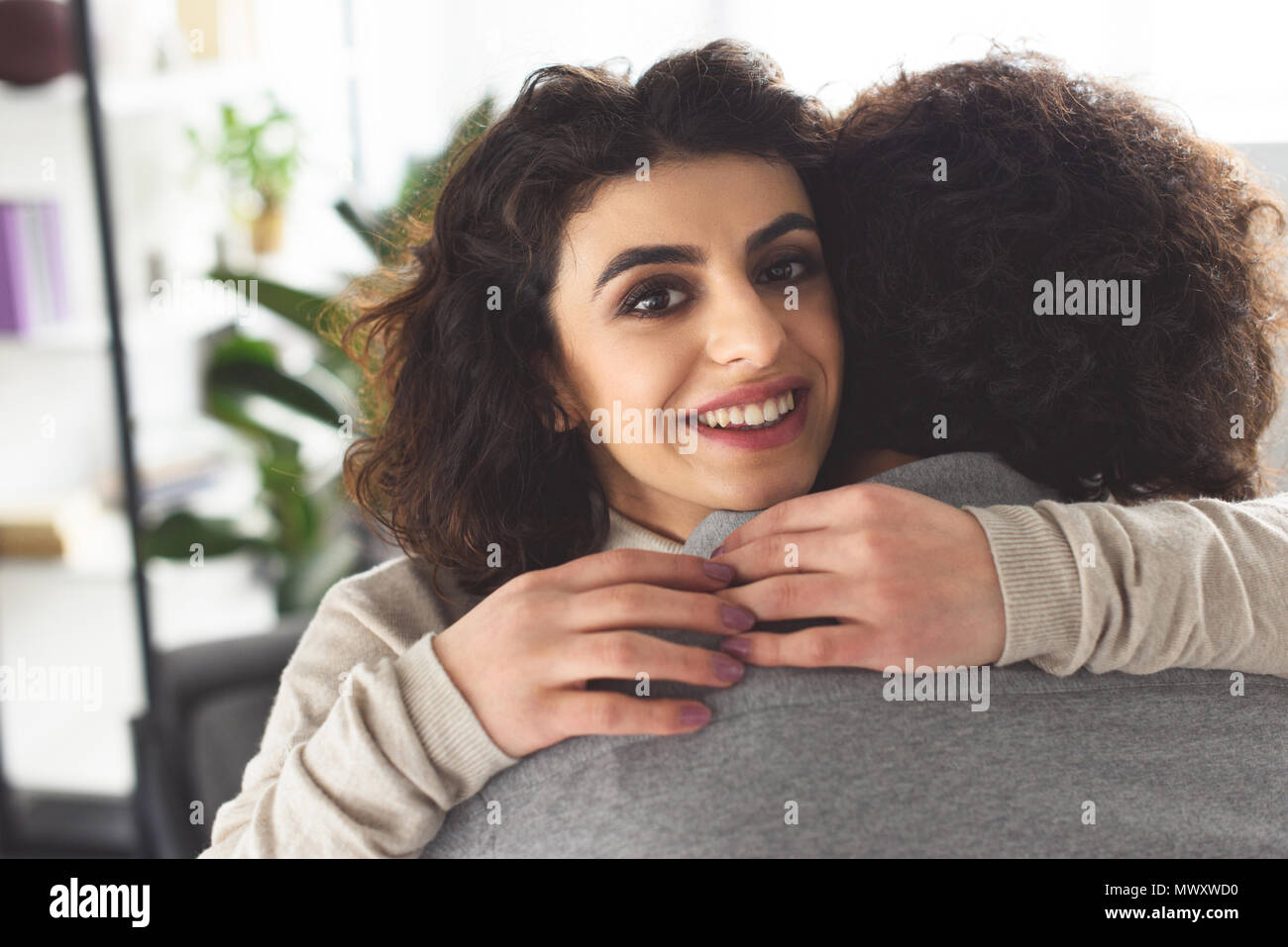 smiling affectionate couple cuddling at home Stock Photo - Alamy