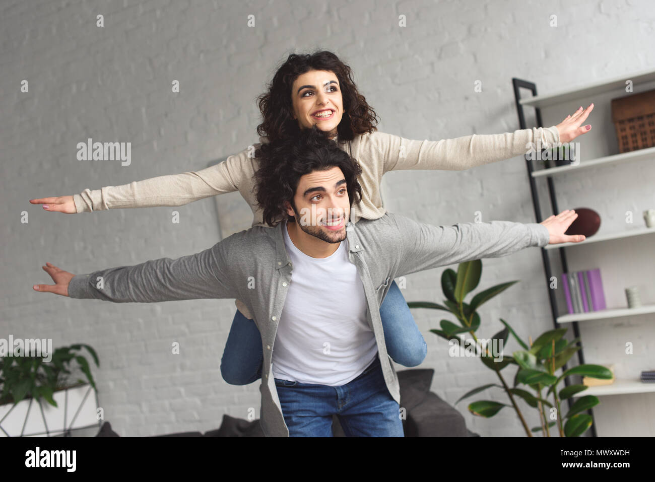 Beautiful young woman giving flying hi-res stock photography and images ...