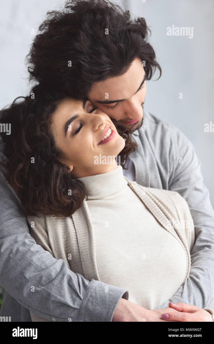 happy tender young couple hugging at home Stock Photo - Alamy