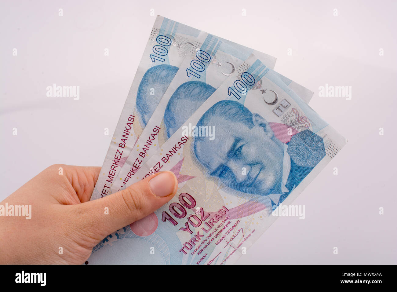 Hand holding 100 Turksh Lira banknotes on white background Stock Photo ...