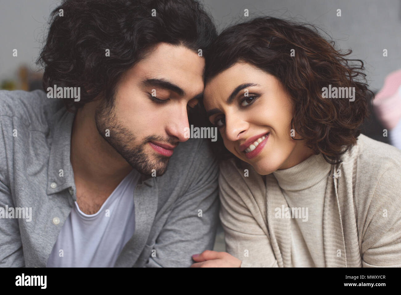 tender affectionate couple touching with foreheads at home Stock Photo ...