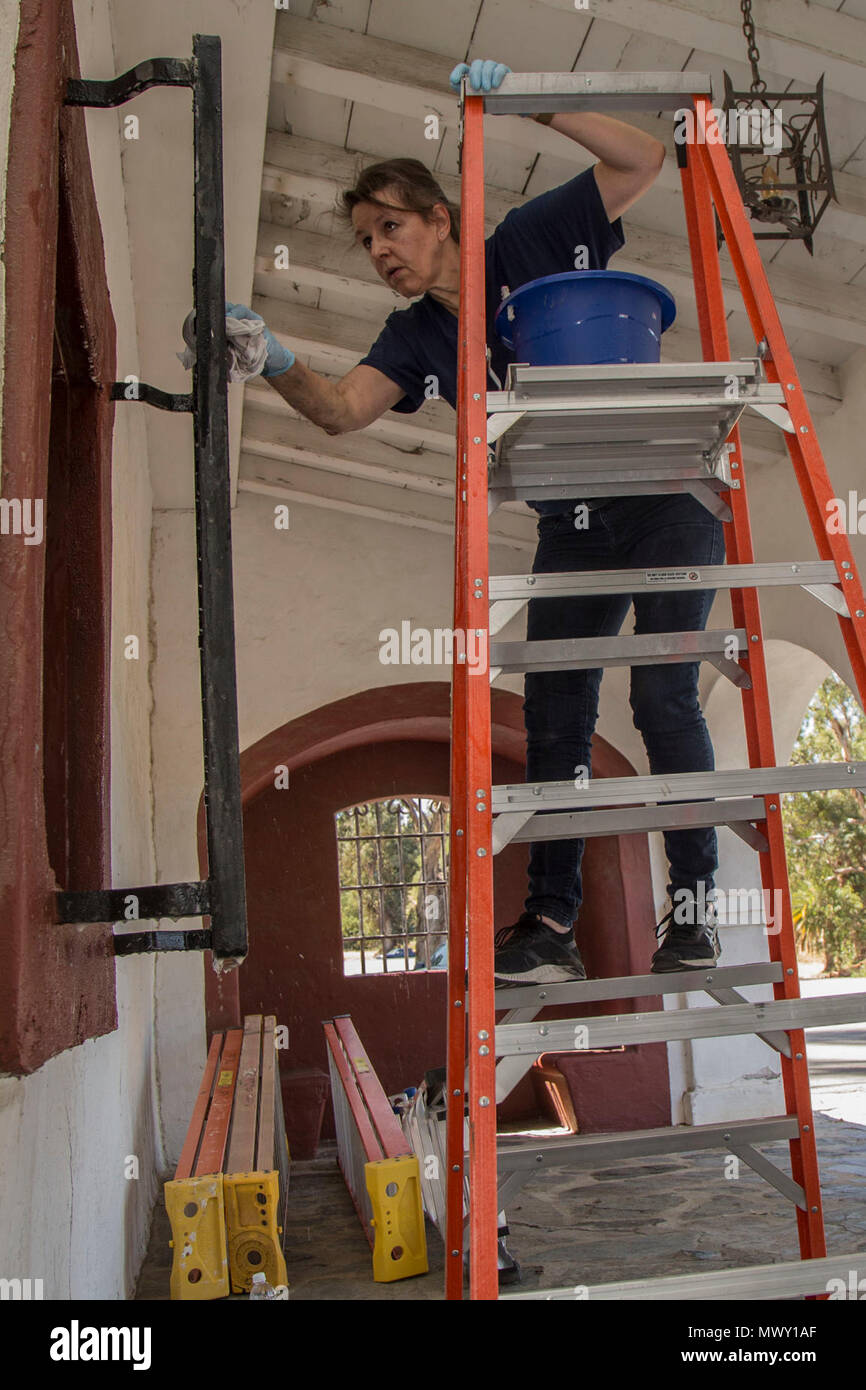 Mrs. Lesly Rhodes, volunteer, performs maintenance on a window at the ...
