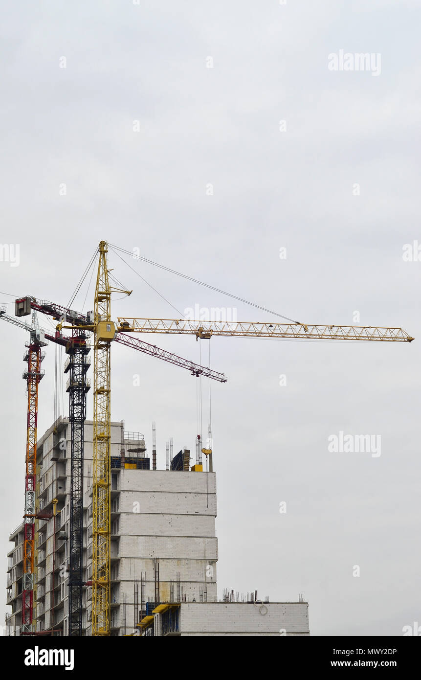 Working tall cranes inside place for with tall buildings under ...