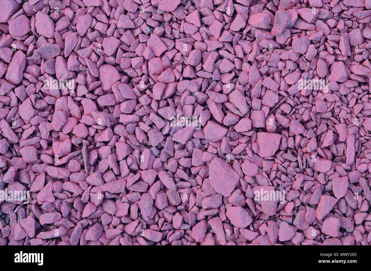 Texture from a pile of crushed stone, painted in light pink color ...