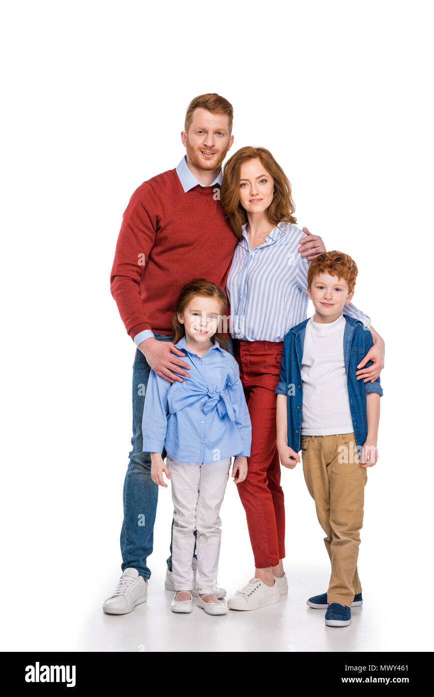 happy redhead family with two children standing together and smiling at ...