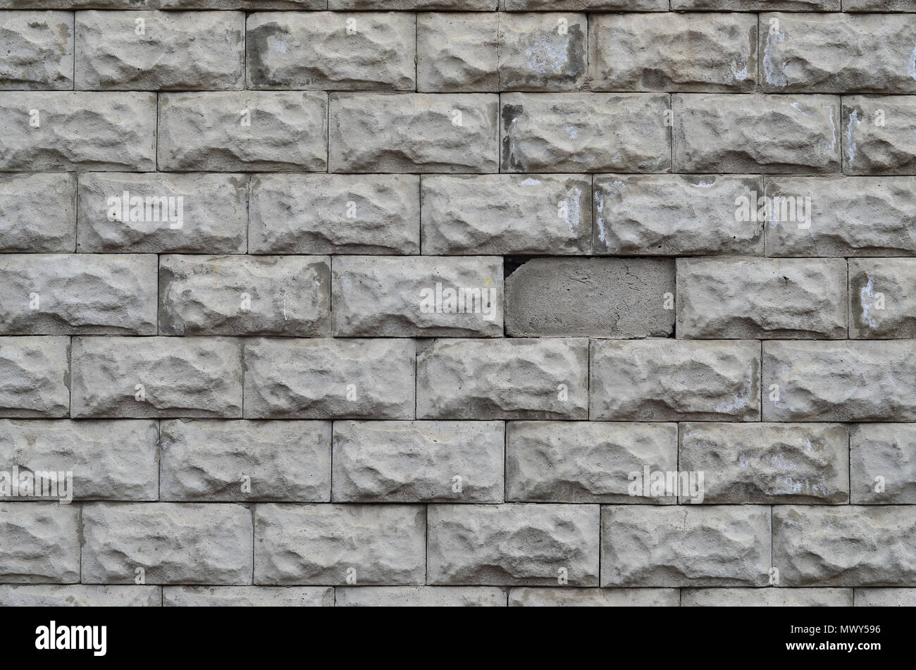 Weathered stained old block wall background. Texture of an old wall of ...