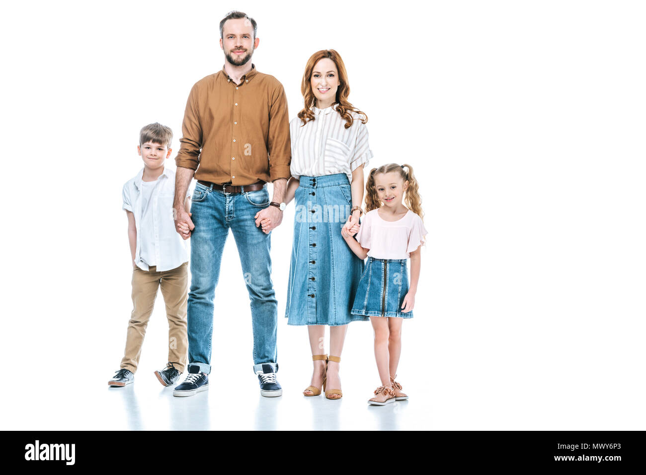 full length view of happy family with two kids standing together and ...