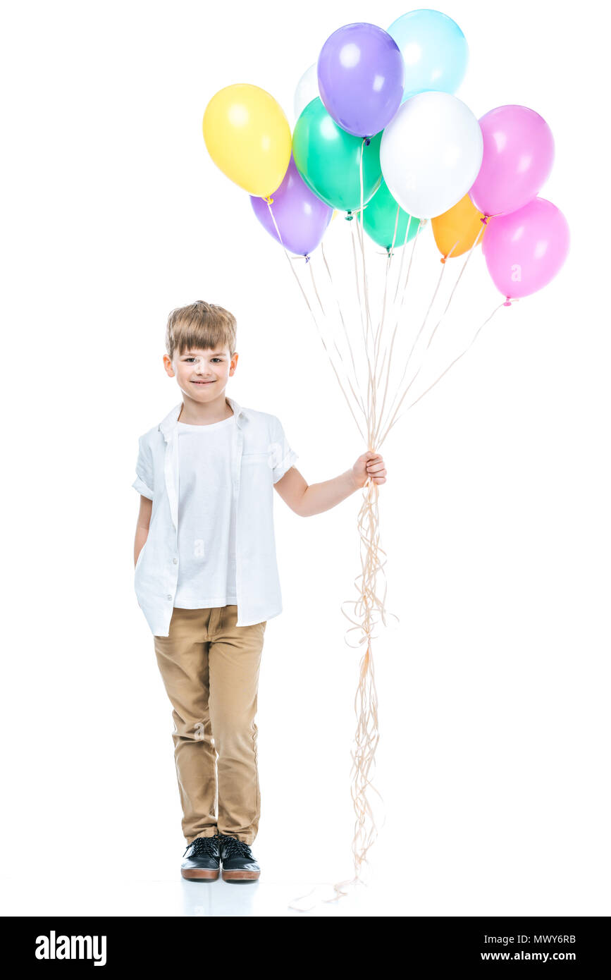adorable little boy holding colorful balloons and smiling at camera ...