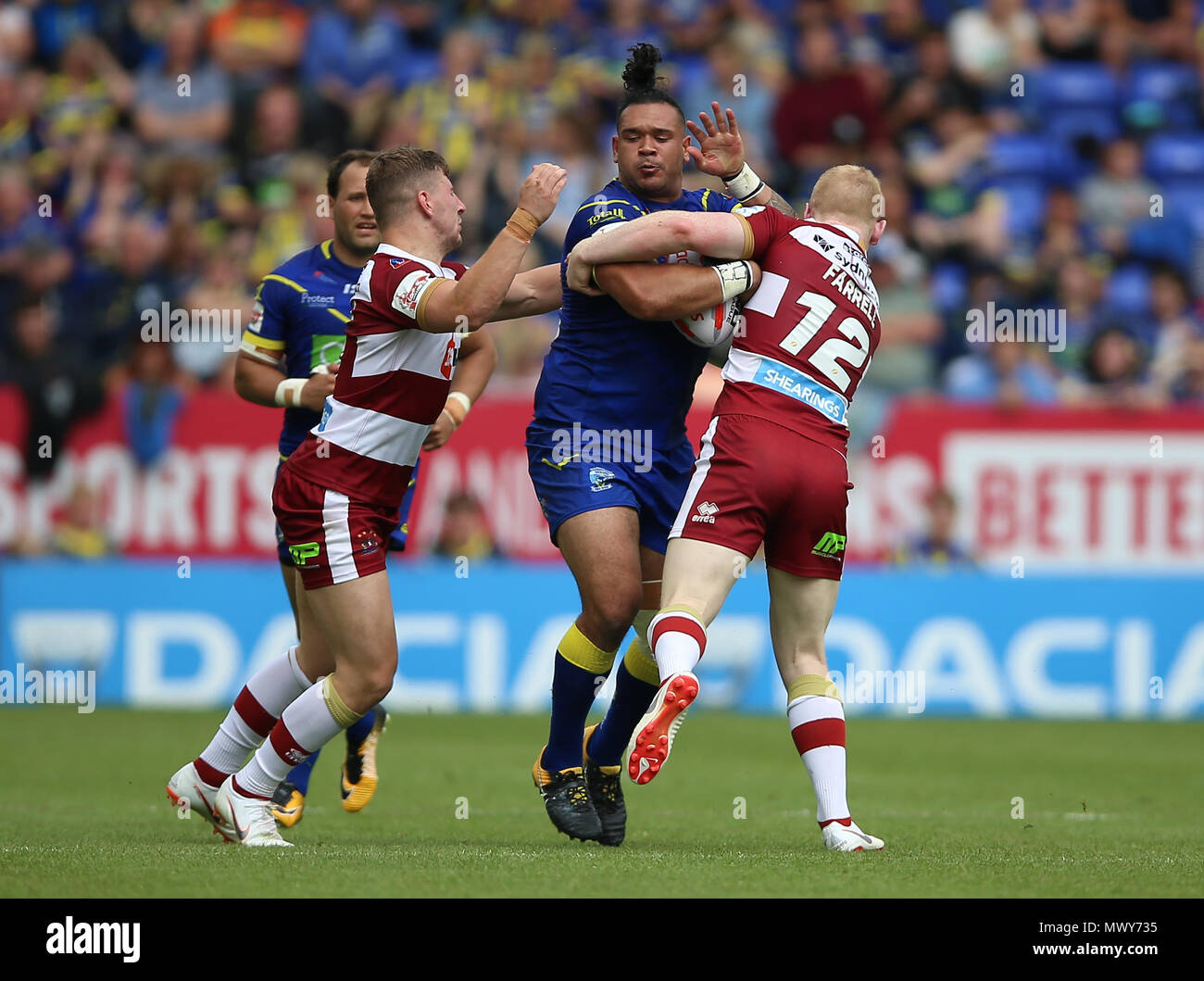 Warrington Wolves Ben Murdoch-Masila is tackled by Wigan Warriors George Williams (left) and ...