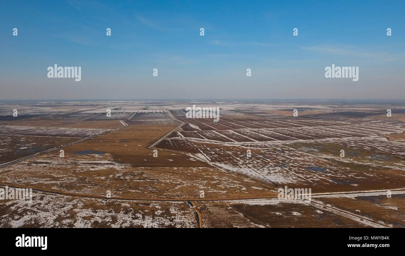 The field covered with snow in a winter season. Aerial view: Winter ...