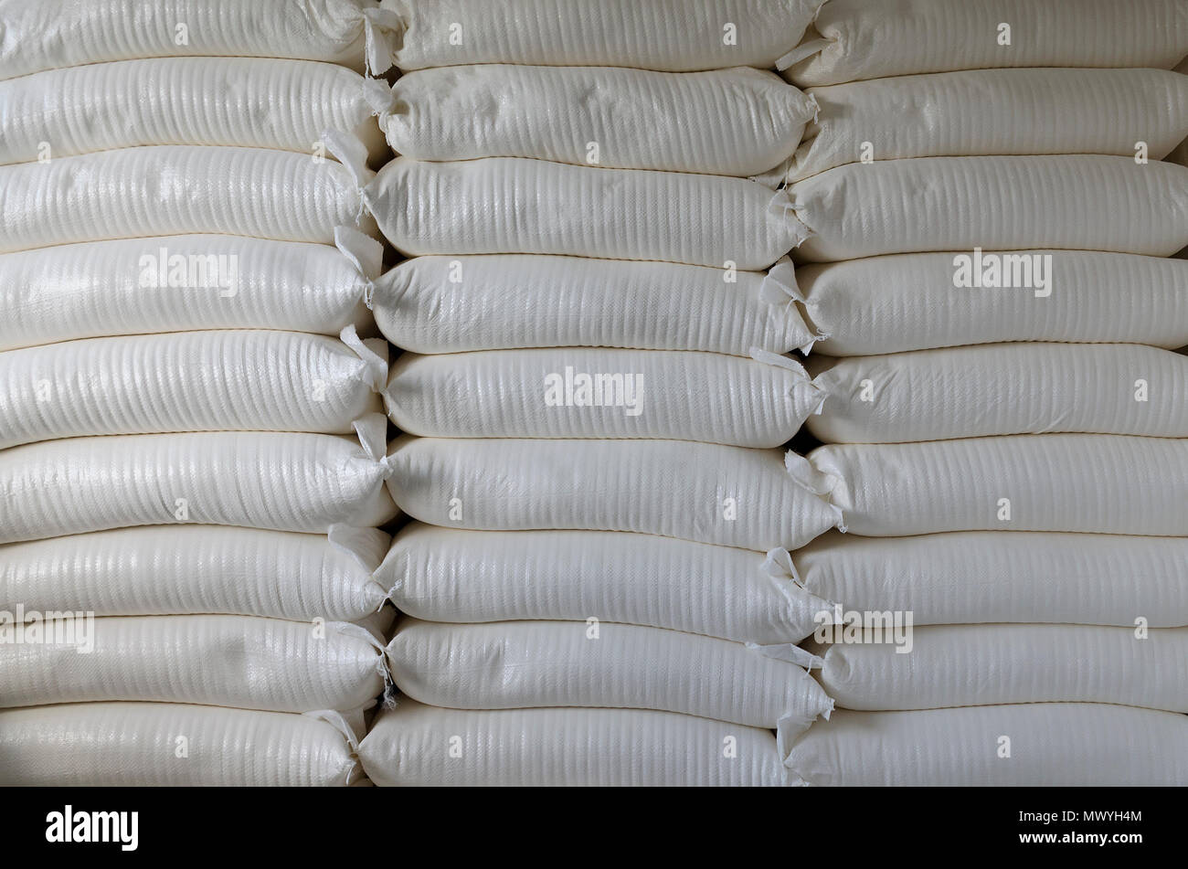 Three piles of big sacks at warehouse in modern factory Stock Photo - Alamy