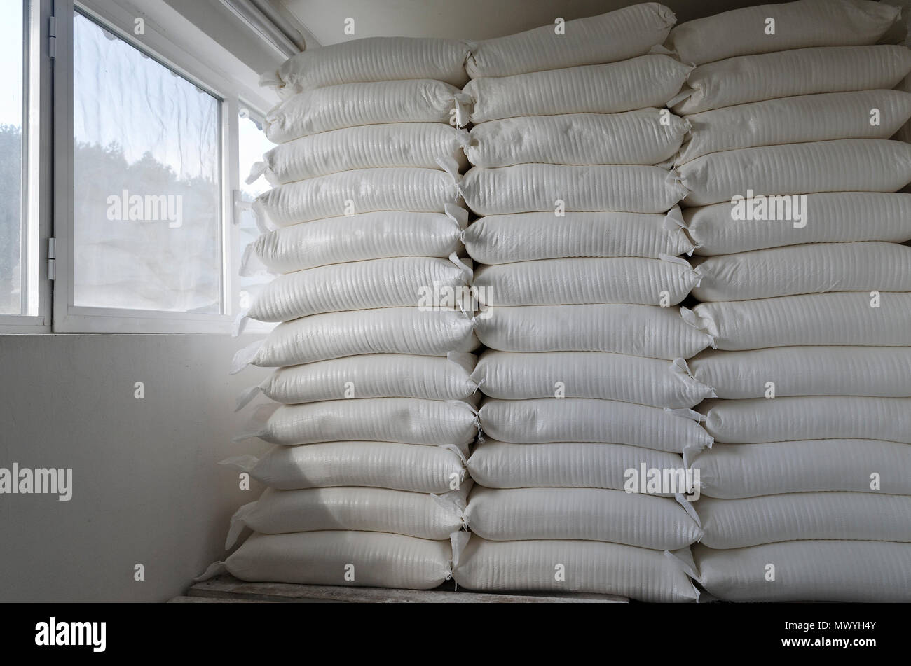 Three piles of big sacks at warehouse in modern factory Stock Photo - Alamy