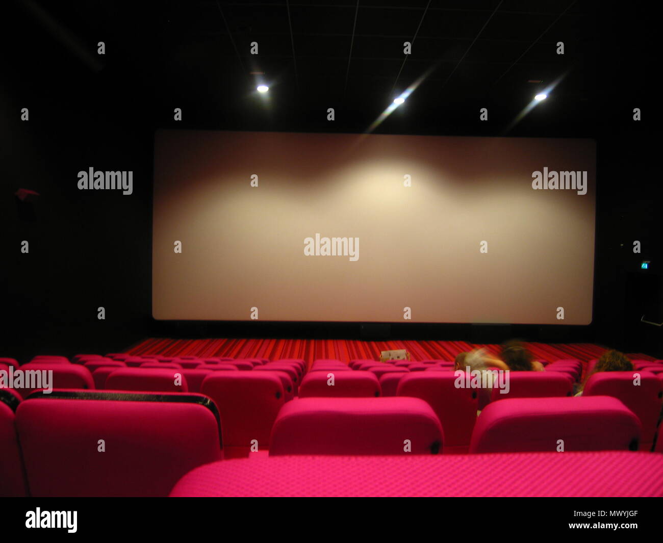 Interior with pink seats of movie theatre Stock Photo - Alamy