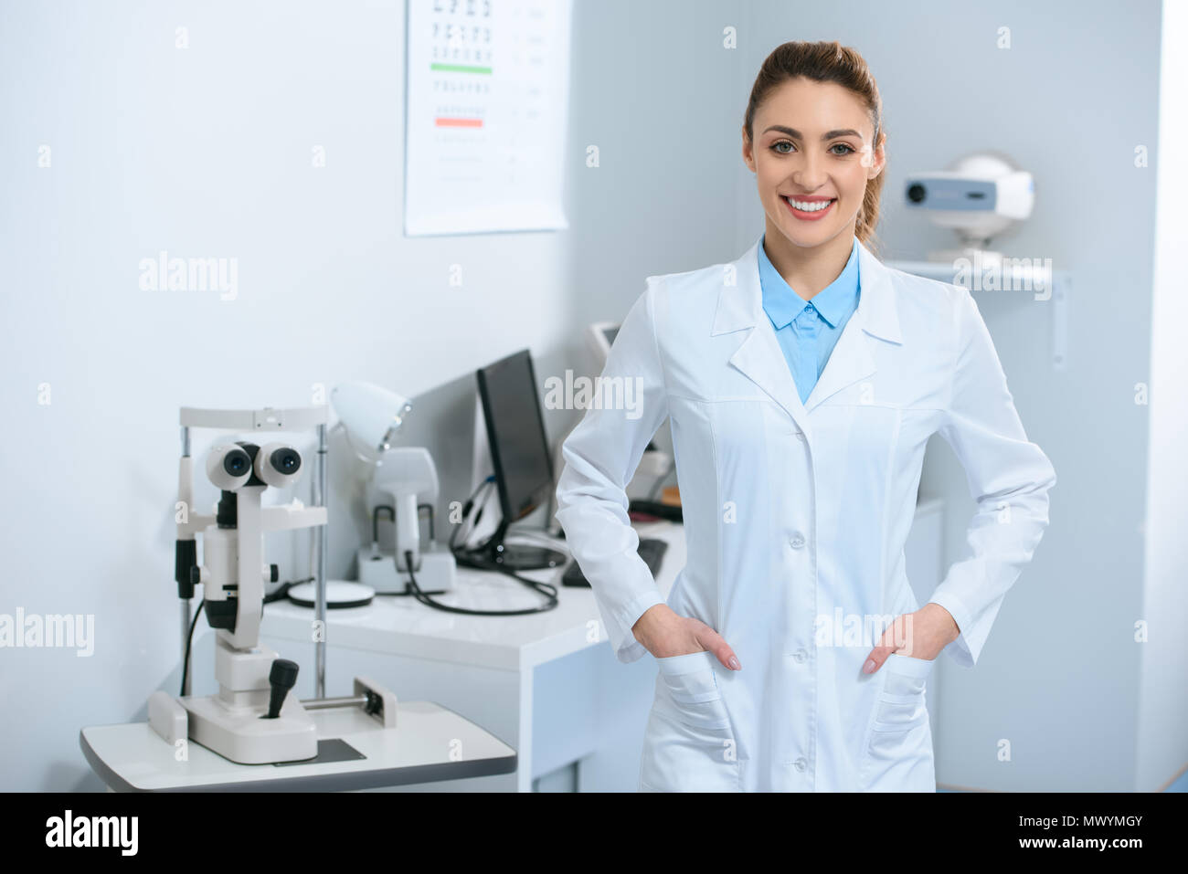 smiling female optometrist posing in optical clinic Stock Photo - Alamy