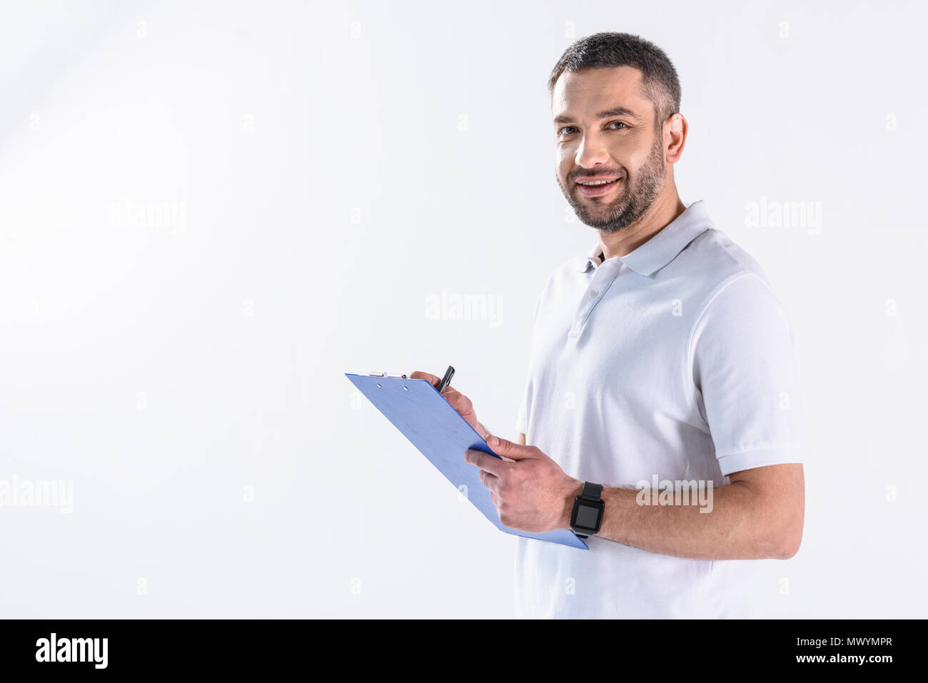 portrait of smiling rehabilitation therapist with notepad isolated on ...