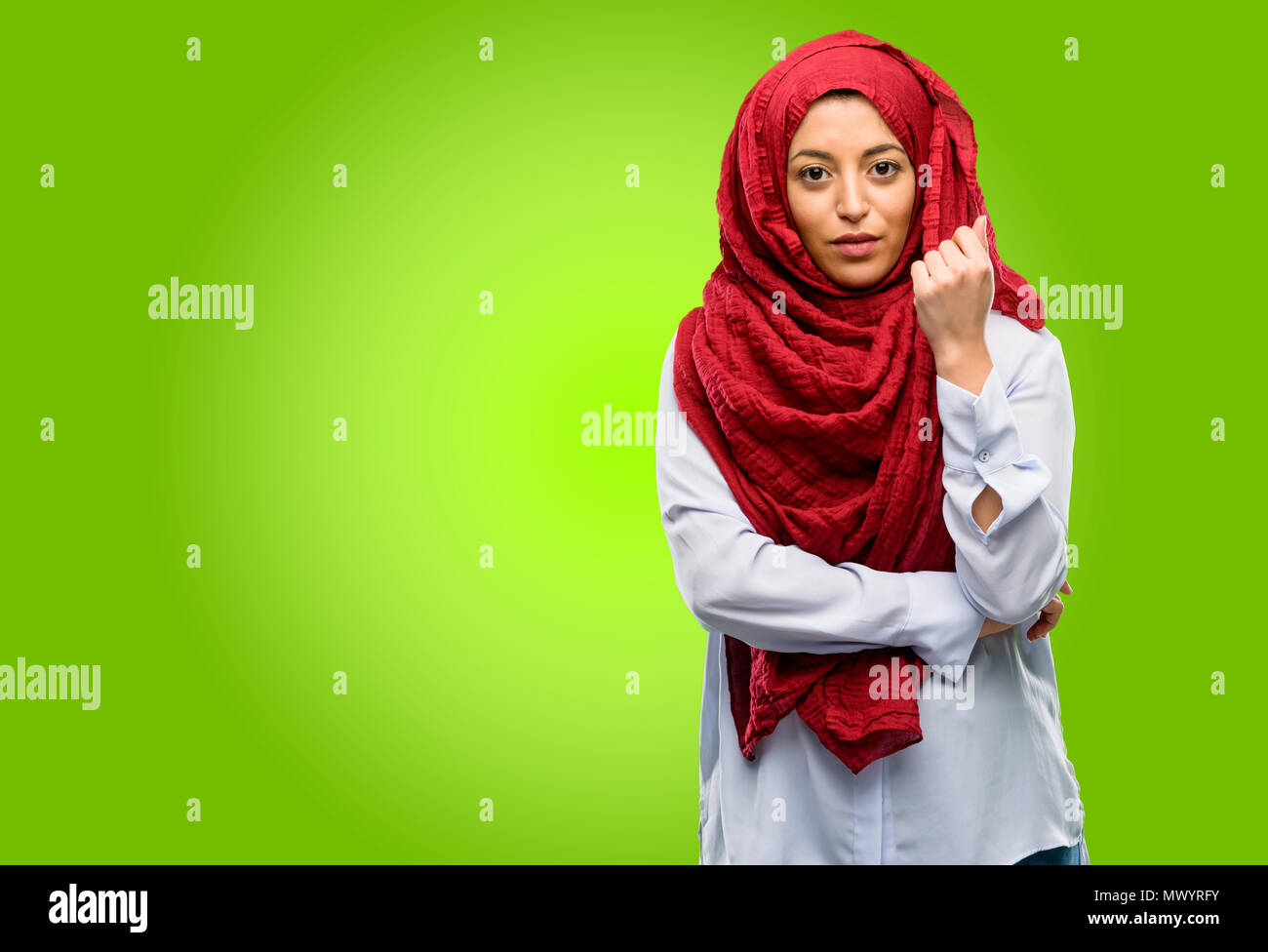 Young arab woman wearing hijab with crossed arms confident and serious ...