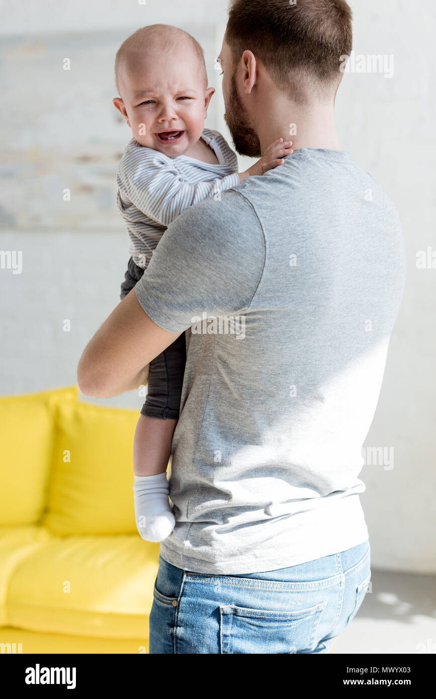 father with little crying son at home Stock Photo - Alamy