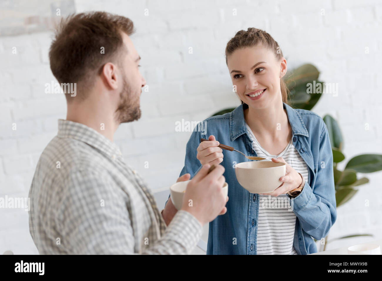 young couple eating corn flakes for breakfast in morning Stock Photo ...