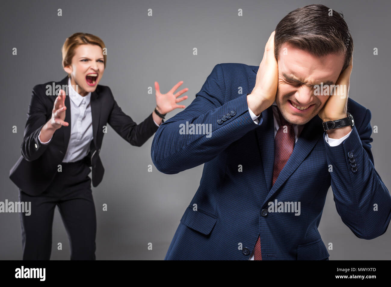 aggressive female boss yelling at frightened businessman, isolated on ...