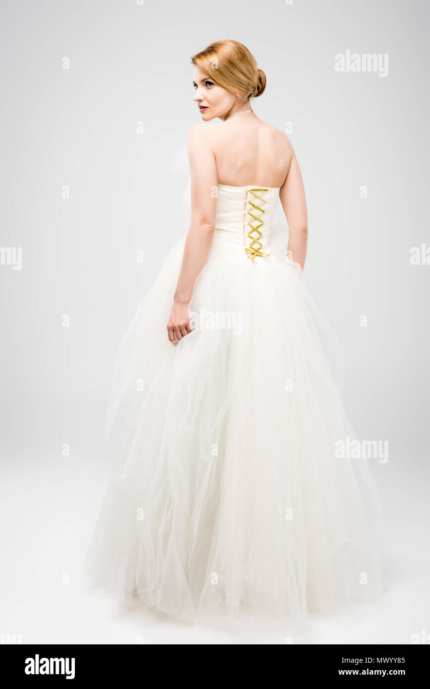 back view of bride in white wedding dress, isolated on grey Stock Photo ...