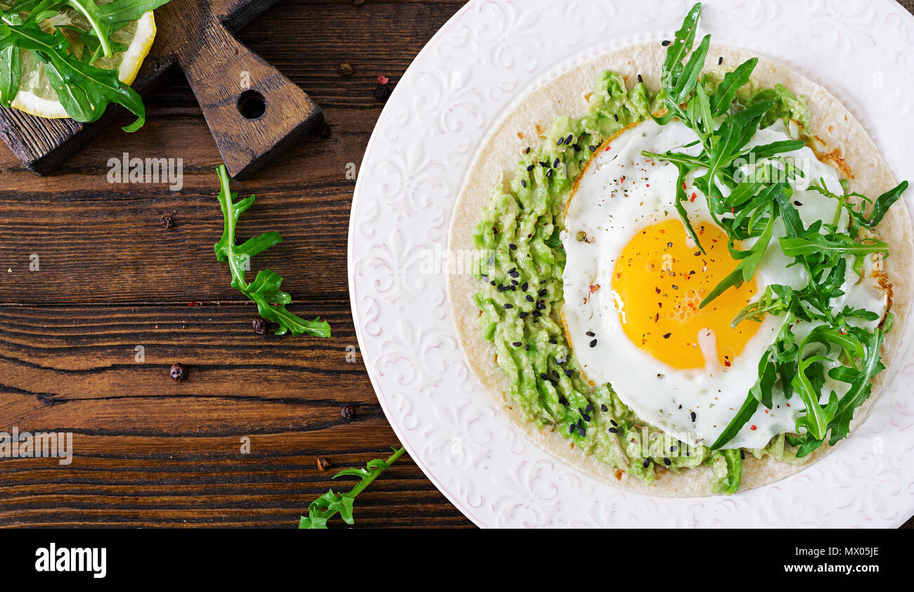 Tacos with guacamole, fried egg and arugula. Healthy food. Useful ...