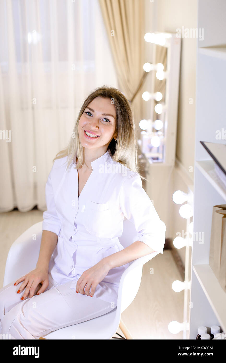 Nice female family doctor sitting at cabinet Stock Photo - Alamy
