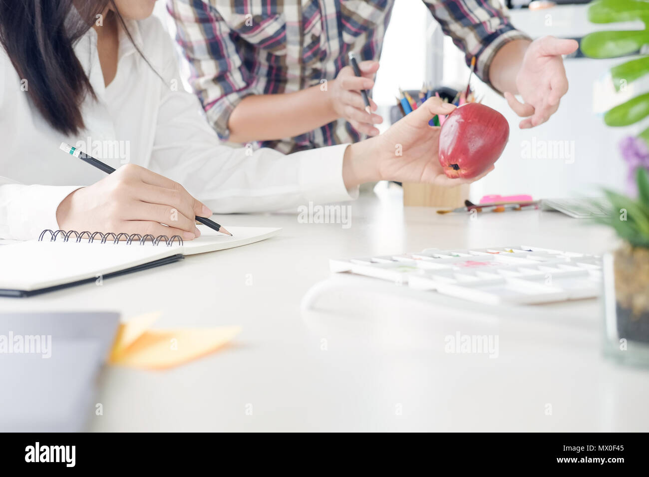 Artist meeting on working table Stock Photo - Alamy