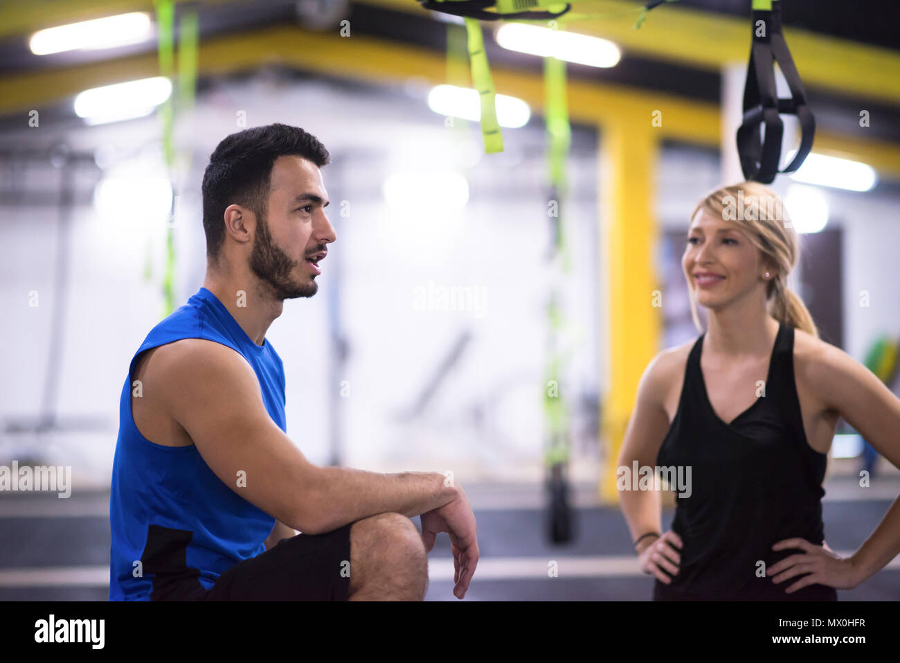 group of young healthy athletic people training jumping on fit box at ...