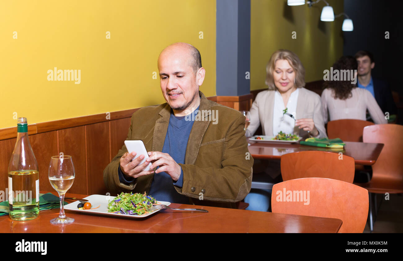 Texting at dinner table hi-res stock photography and images - Alamy