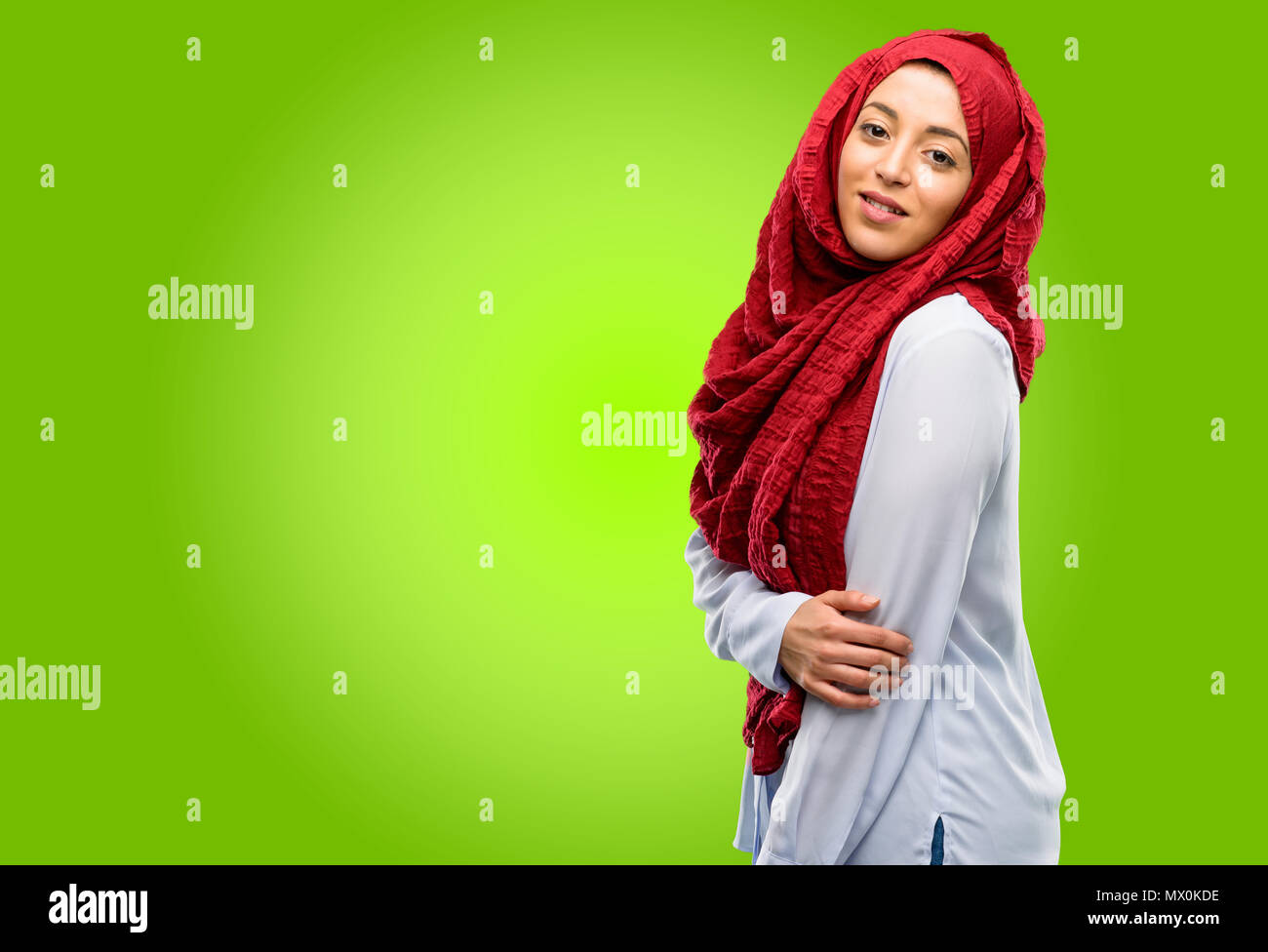 Young arab woman wearing hijab confident and happy with a big natural ...