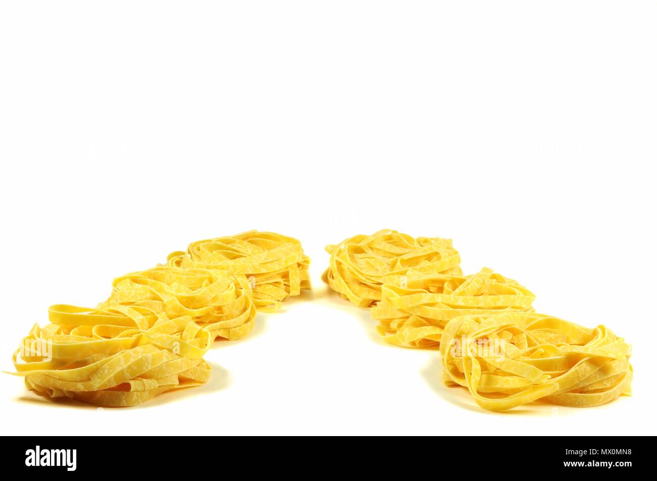 Six traditional italian pasta tagliatelle nests isolated on white ...