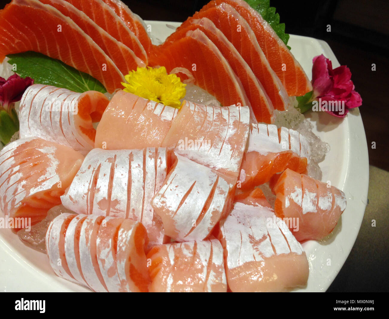 Japanese sashimi salmon buffet in white disk with ice Stock Photo - Alamy