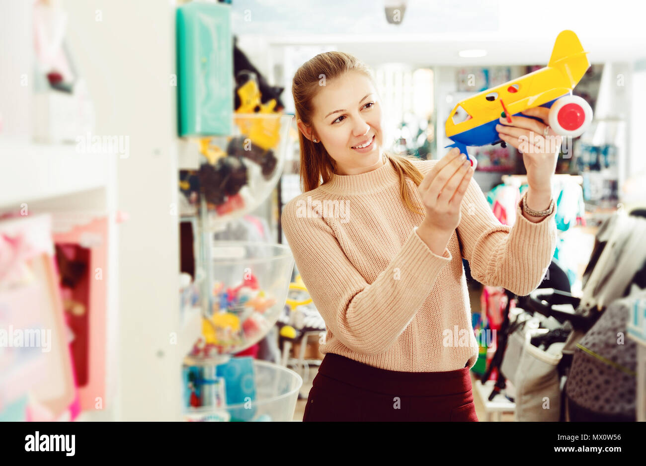glad consumer with children's plastic toys in the kids store Stock ...