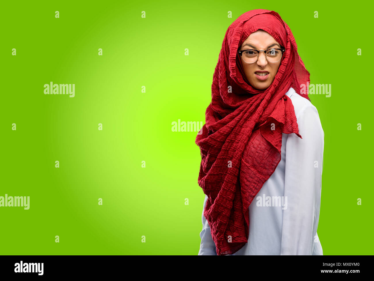 Young arab woman wearing hijab angry and stressful frowns face in ...