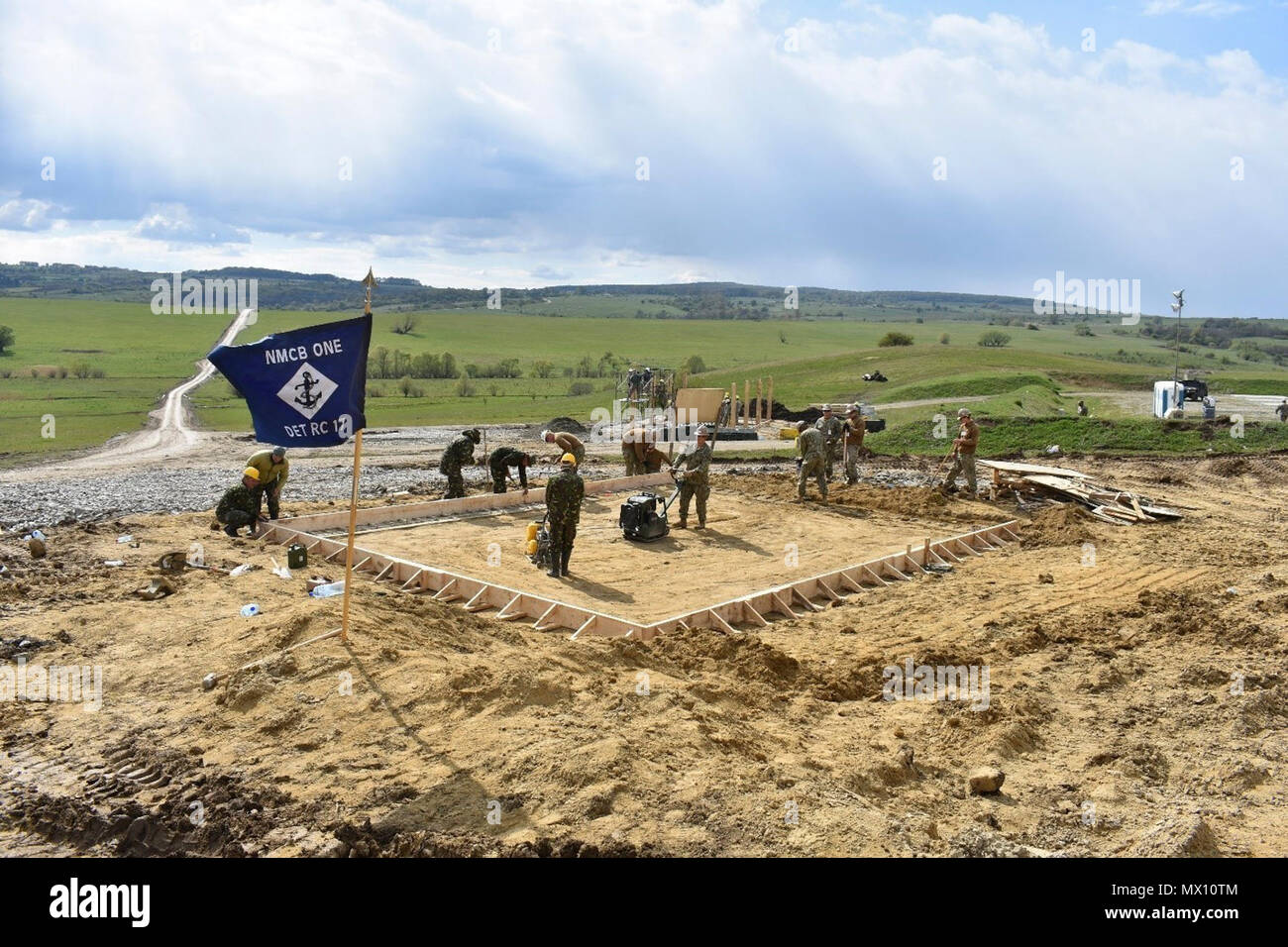 Sailors of the Naval Mobile Construction Battalion 1 work with soldiers ...