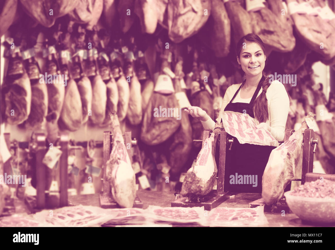 happy russian female butcher with lard and meat in counter of store ...
