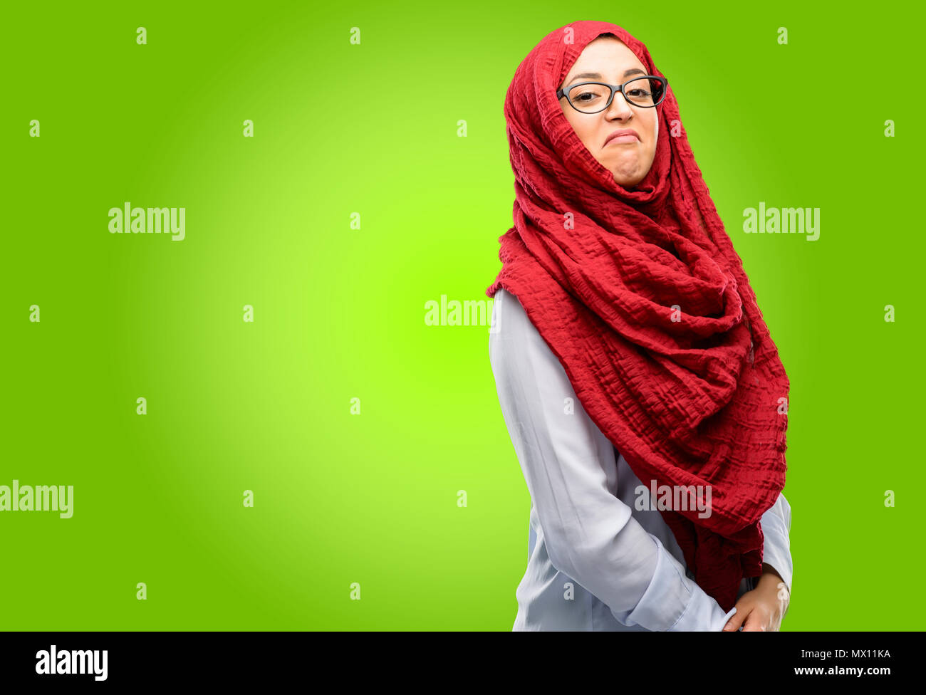 Young arab woman wearing hijab having skeptical and dissatisfied look ...