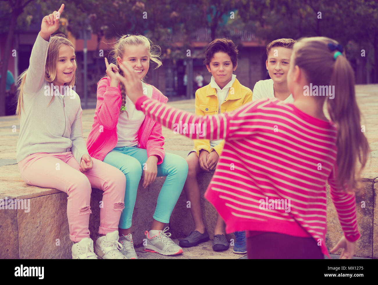 Small children talking on playground hi-res stock photography and ...