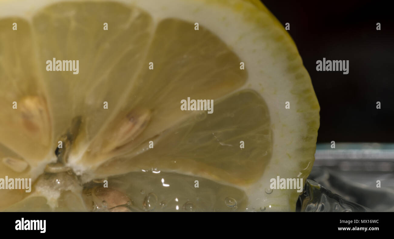 Isolated macro of a lemon slice in water background Stock Photo - Alamy
