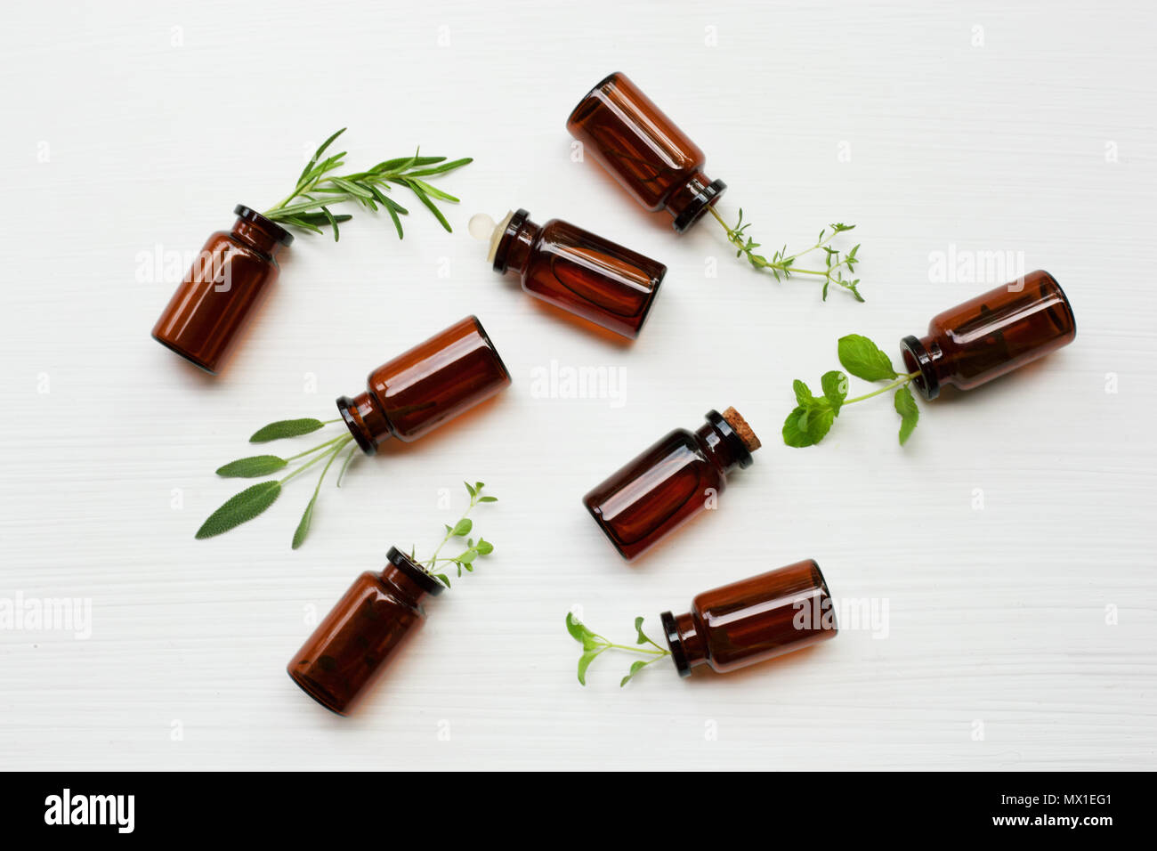 Top view, Bottle of essential oil with herbs Stock Photo - Alamy