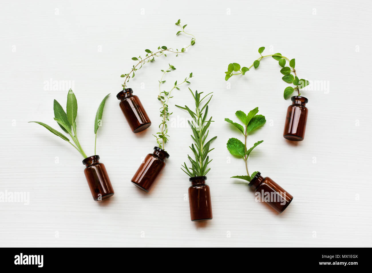 Top view, Bottle of essential oil with herbs Stock Photo - Alamy