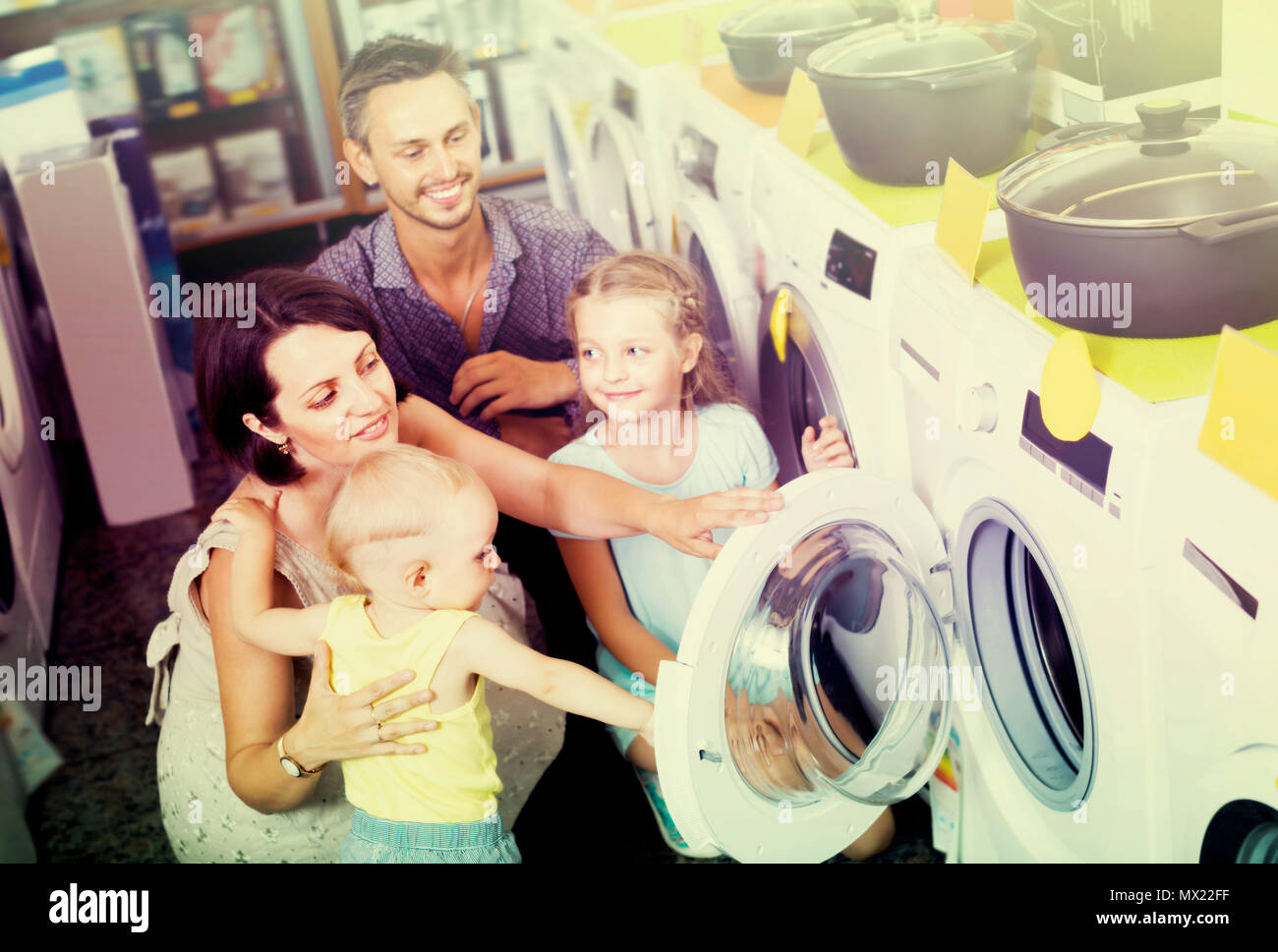 Adult happy family together choosing washing machine in shop of ...