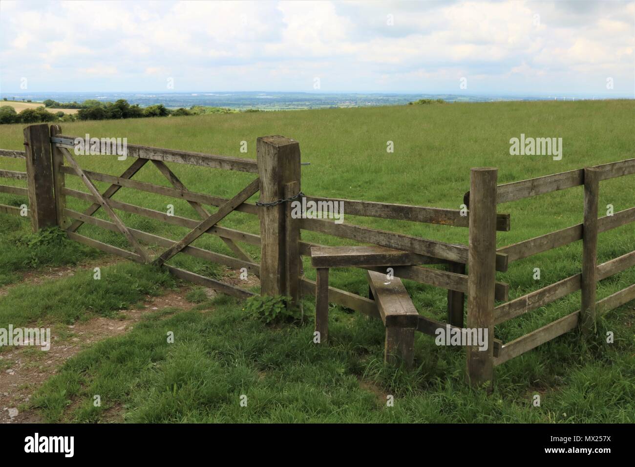 Beautiful scene of a wooden stile and fence against a countryside ...