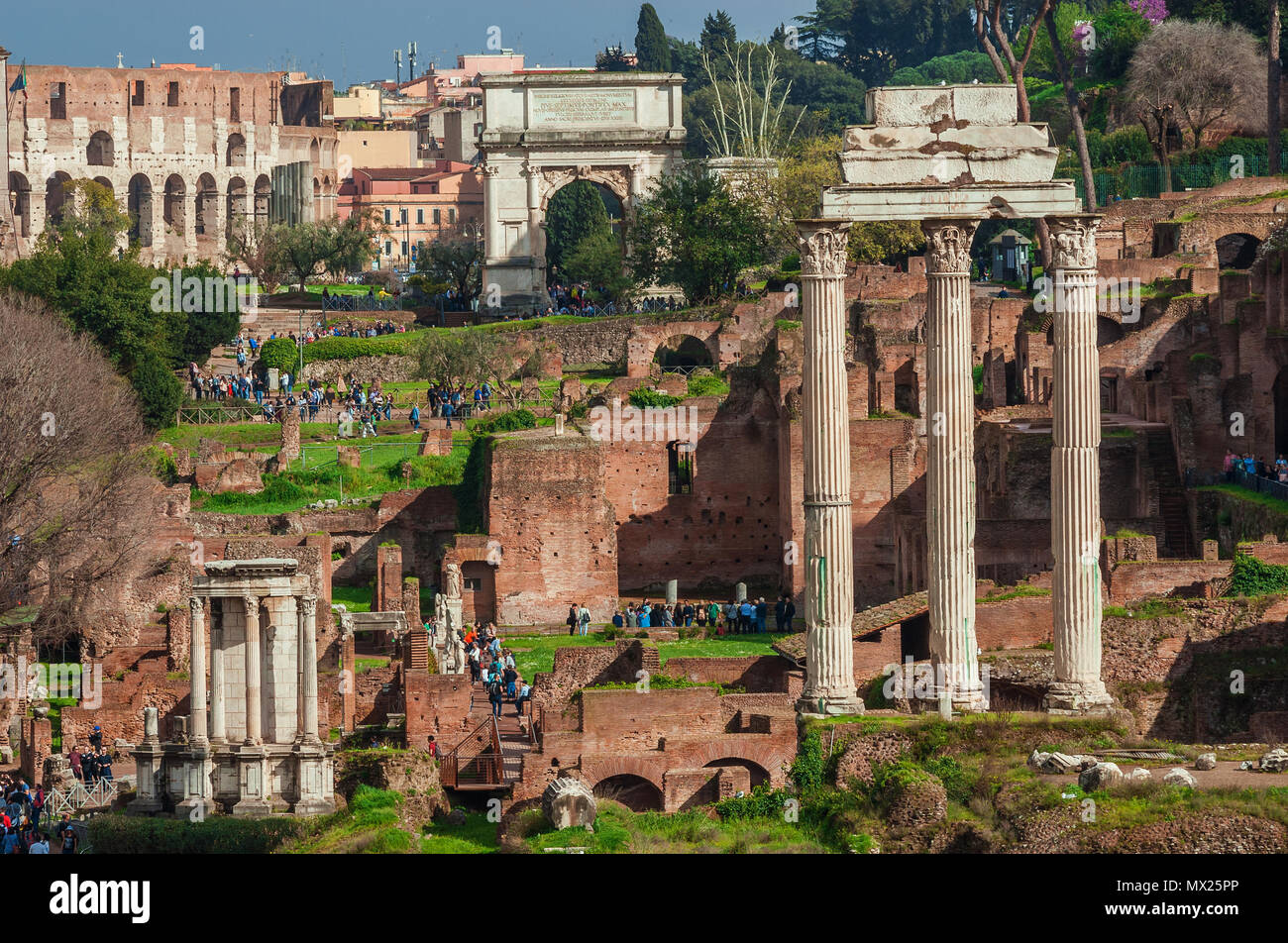 Visiting Roman Forum. Tourists walking among ancient ruins with ...