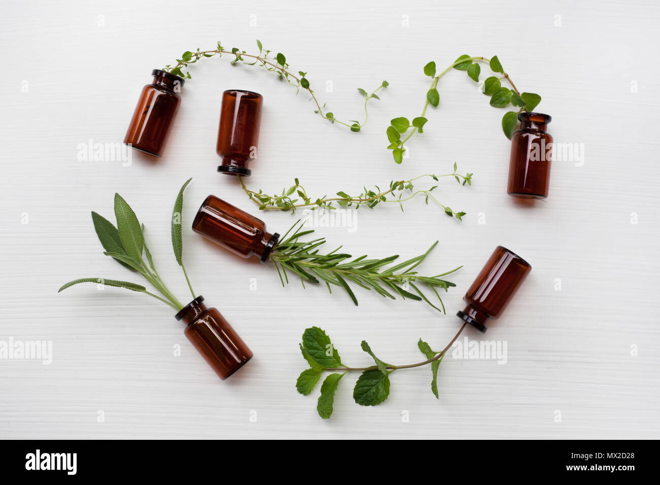 Top view, Bottle of essential oil with herbs Stock Photo - Alamy