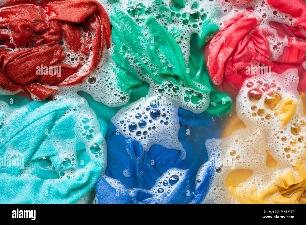 Soak a cloth before washing, Color clothes Stock Photo - Alamy