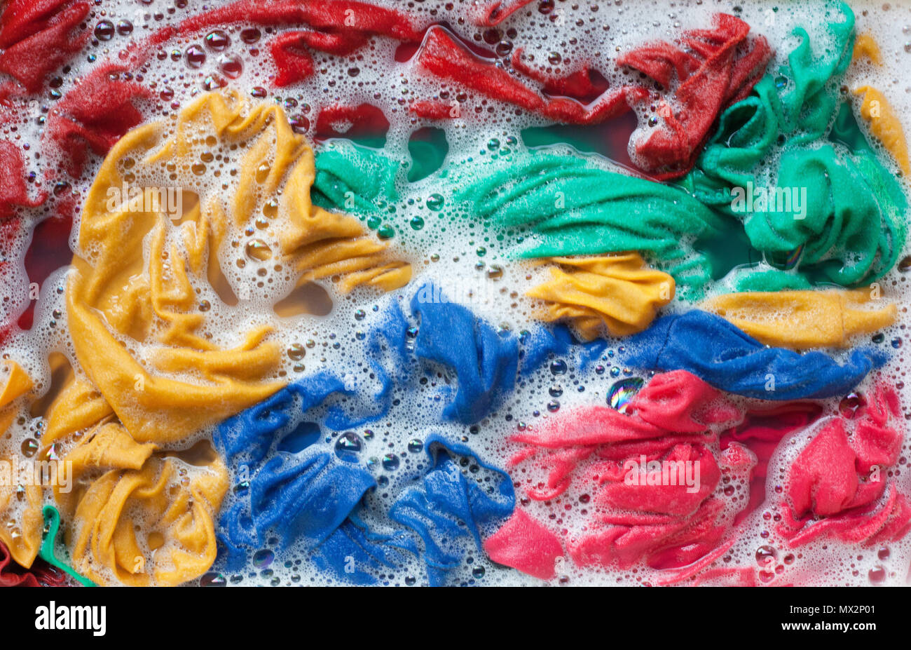 Soak a cloth before washing, Color clothes Stock Photo - Alamy